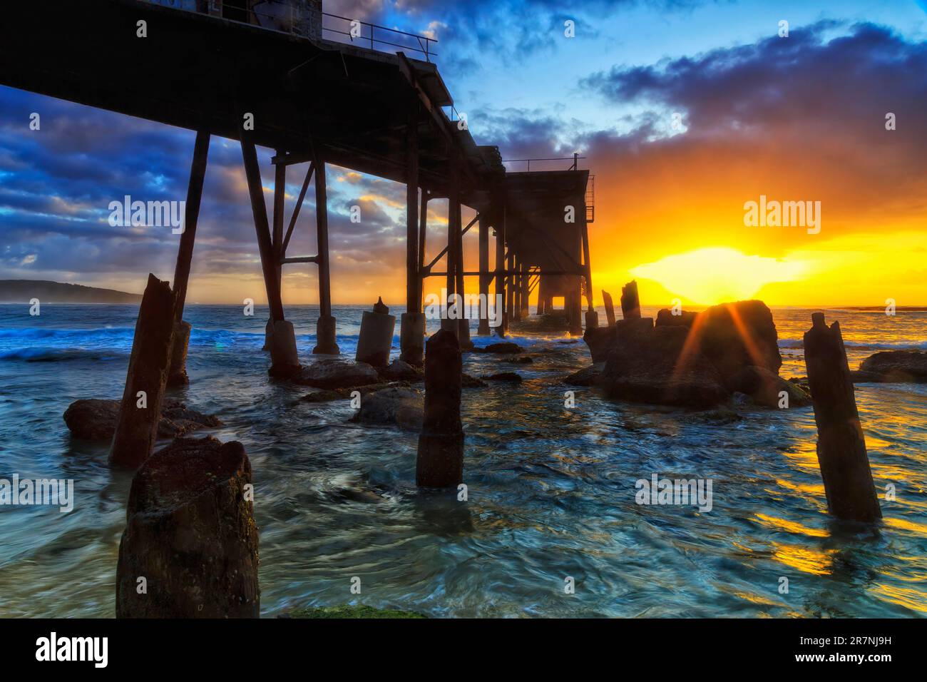 Old historic broken timber jetty at Middle camp beach of catherine hill ...