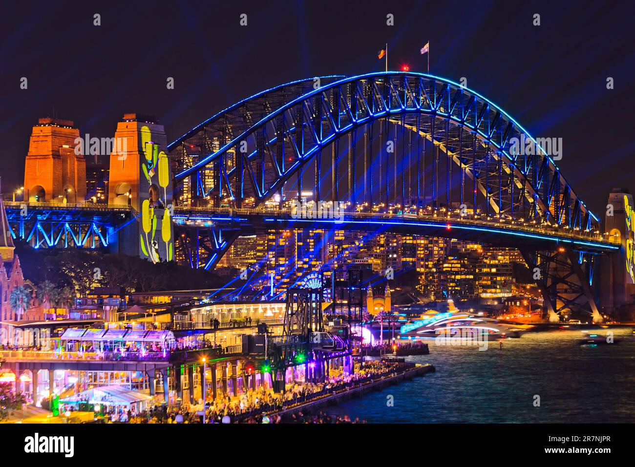 Sydney harbour bridge arch across harbour with bright lights at Vivid ...