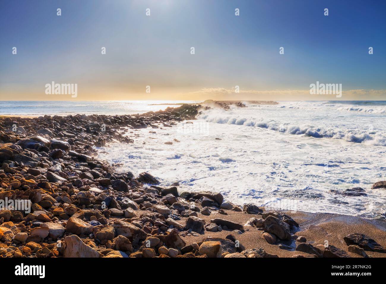 Long scenic spoon rock cape breakwater at Quarry beach in Caves beach ...