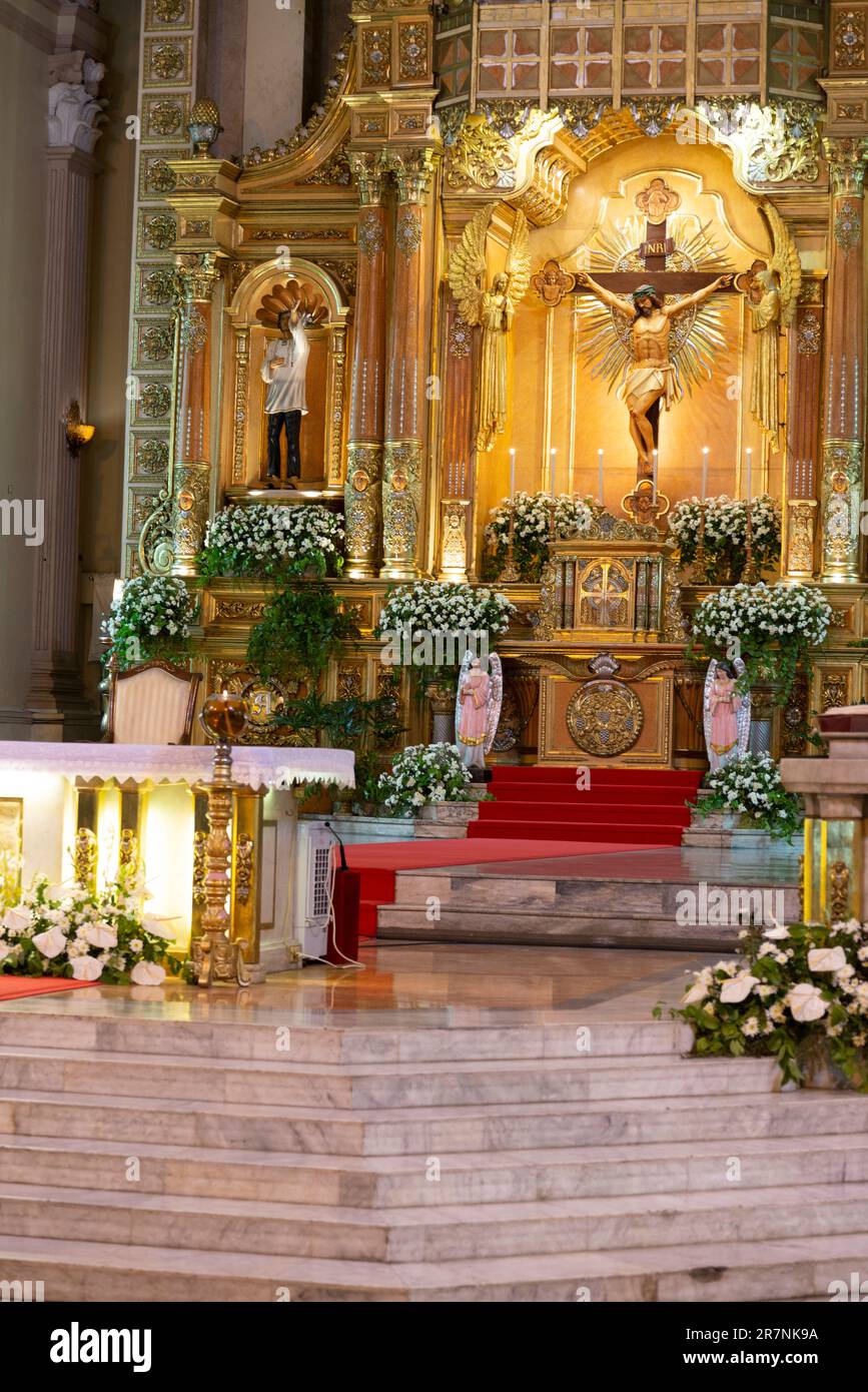 Beautiful gold,illuminated cathedral altar,with large statue of Christ ...