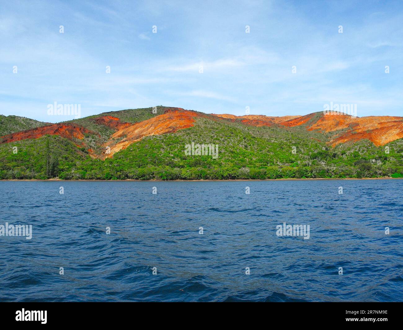 Iron and nickel ore rich soil of New Caledonia, red hills and lush ...