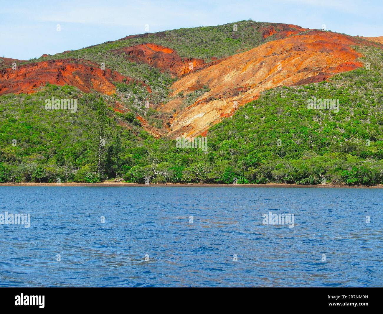 Nickel and iron ore rich soil of New Caledonia, red hills and lush ...
