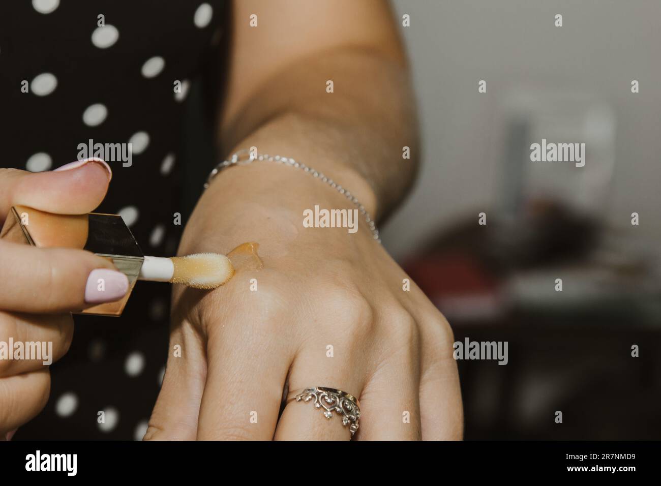 Makeup artist applies pink lipstick shine. Beautiful female face. Hand ...