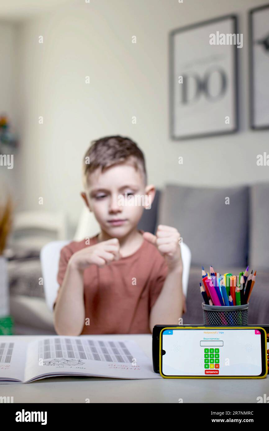 Little preschooler counting large numbers on his fingers using mental ...