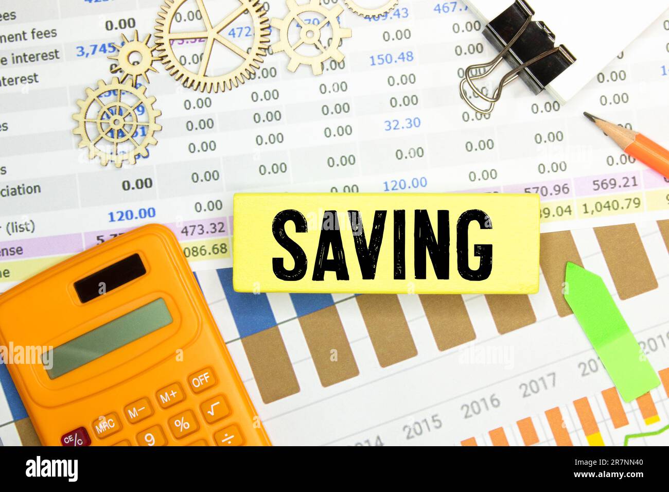 Saving money symbol. Concept words Saving money on wooden blocks on a ...