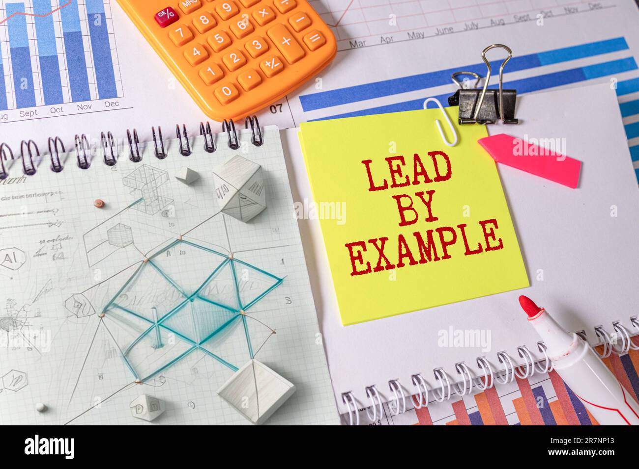 Text LEAD BY EXAMPLE on Office desk table with keyboard, notepad and ...