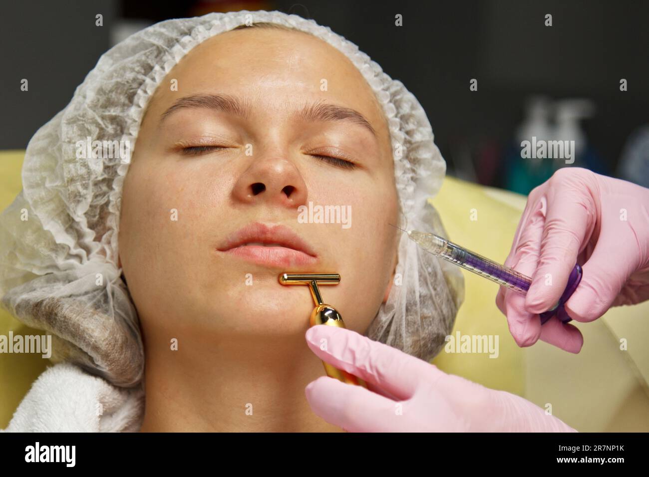 contour plastic. A cosmetologist injects a botulinum toxin to tighten ...
