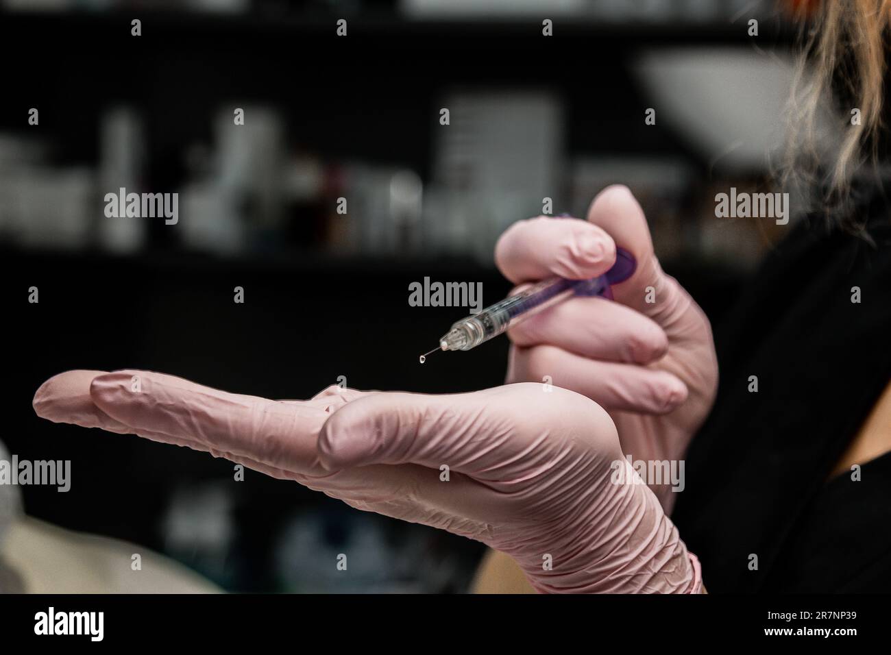 contour plastic. A cosmetologist injects a botulinum toxin to tighten ...