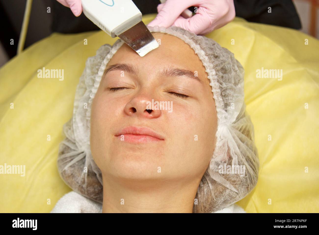 close-up. Ultrasonic face cleaning. Modern equipment. Beautician does ...
