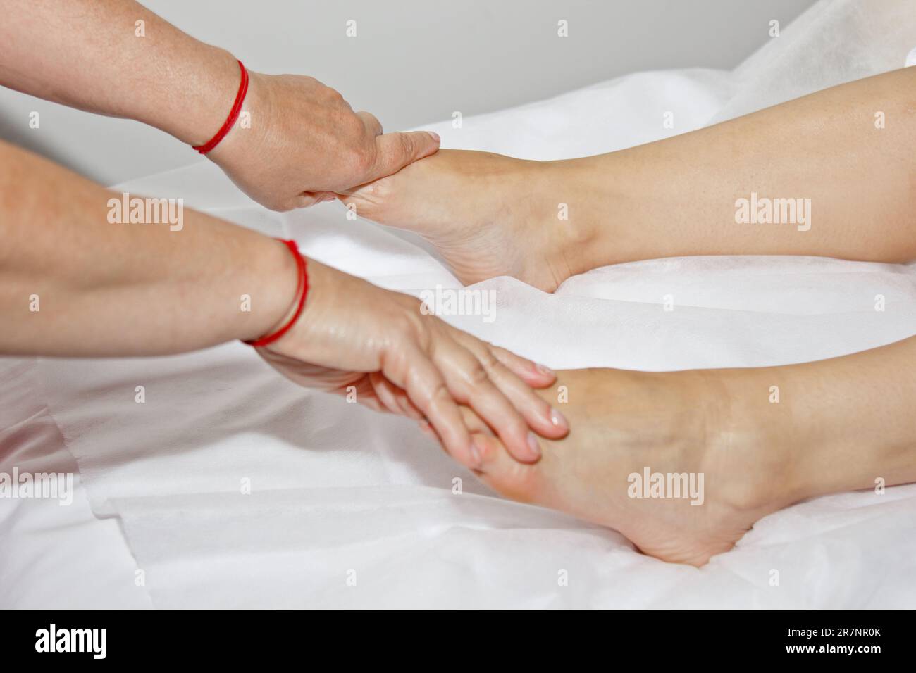 professional therapeutic foot massage. Woman doctor massages the ...