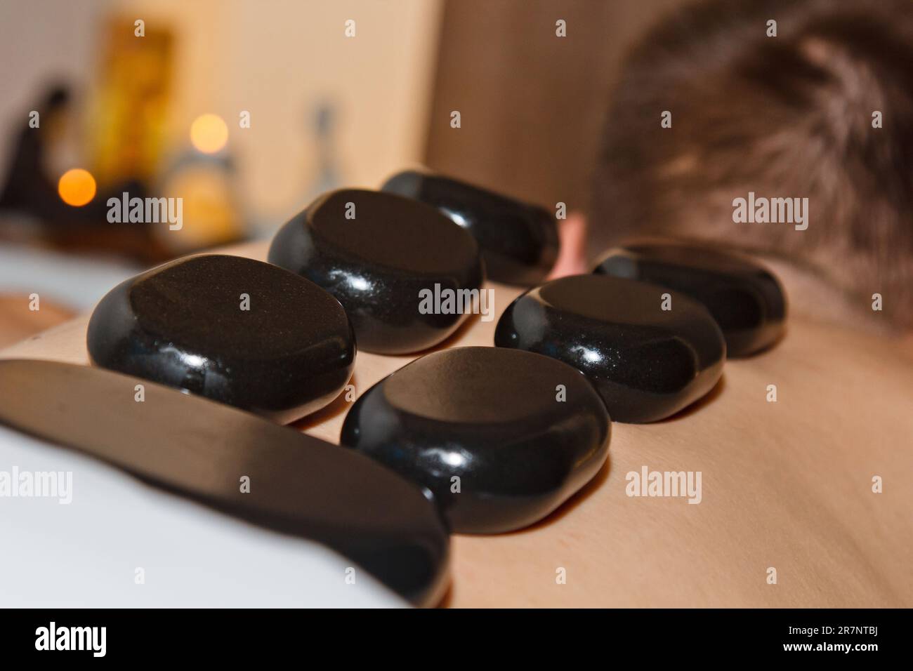 Wellness concept. Handsome young man relaxing under the stimulating ...