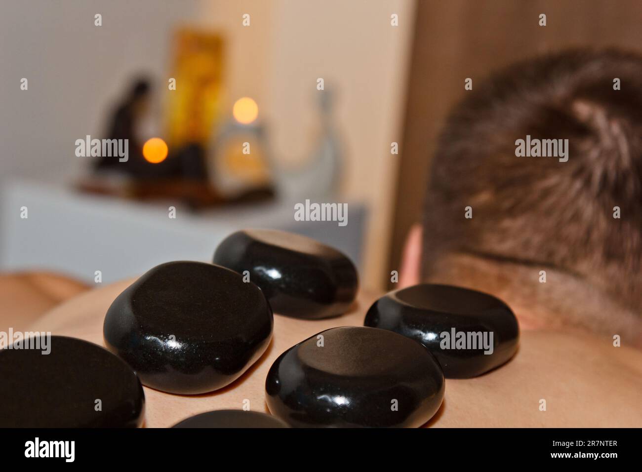 Wellness concept. Handsome young man relaxing under the stimulating ...