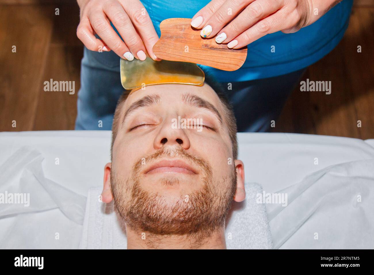 Wellness concept. Professional masseur gives a man a Thai facial ...