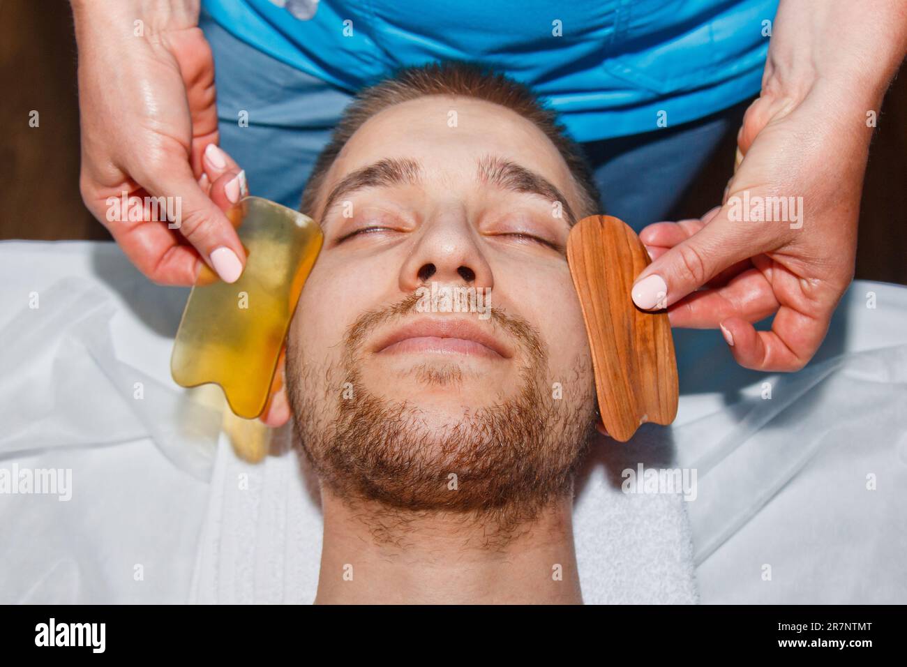 Wellness concept. Professional masseur gives a man a Thai facial ...