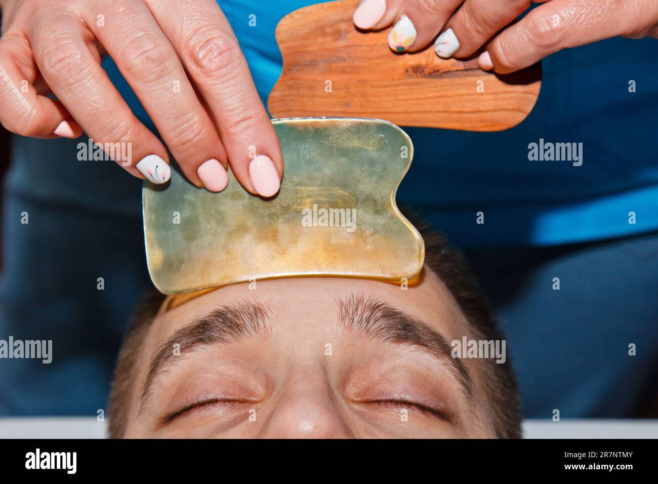 Wellness concept. Professional masseur gives a man a Thai facial ...