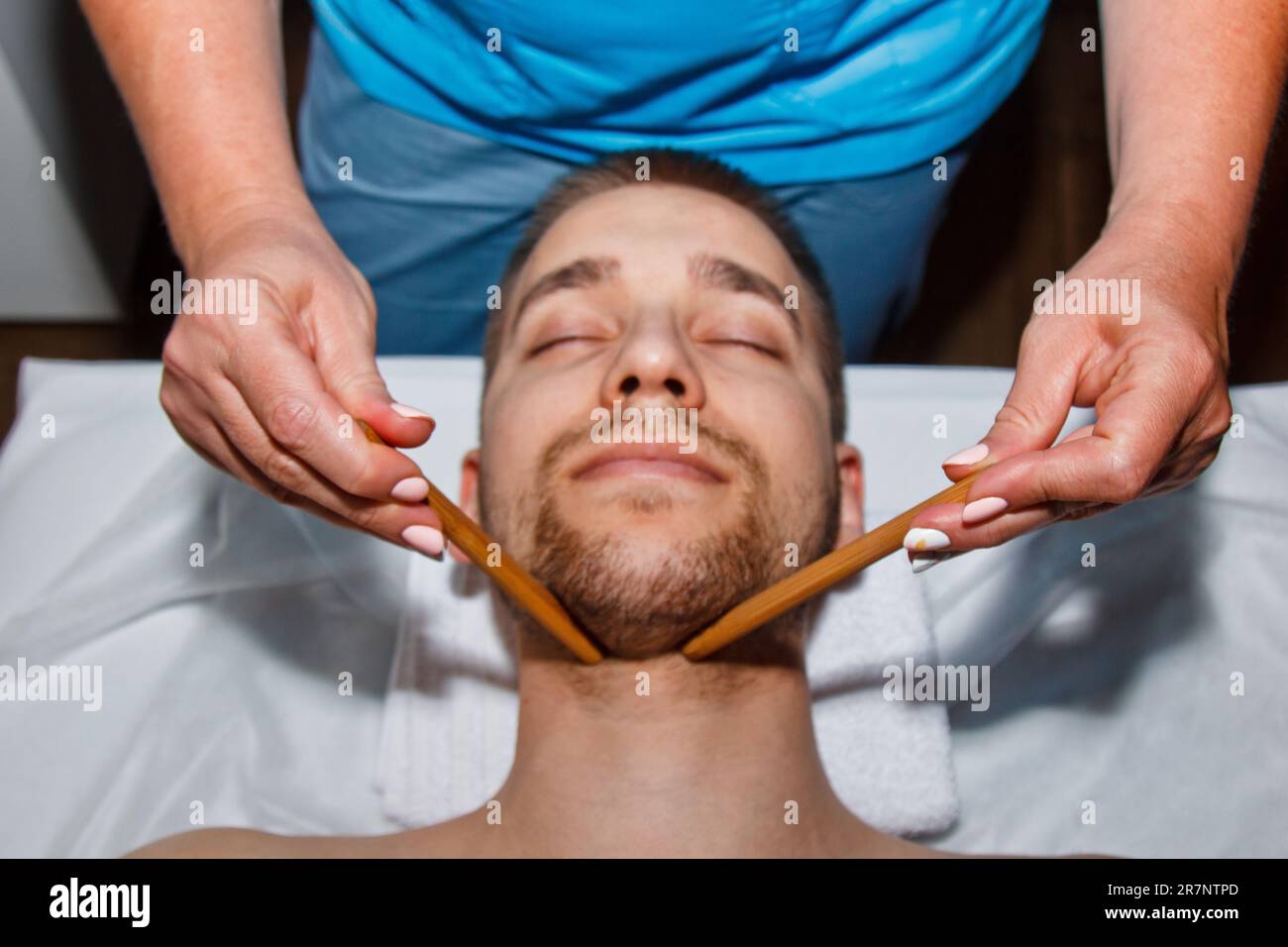 Wellness concept. Professional masseur gives a man a Thai facial ...