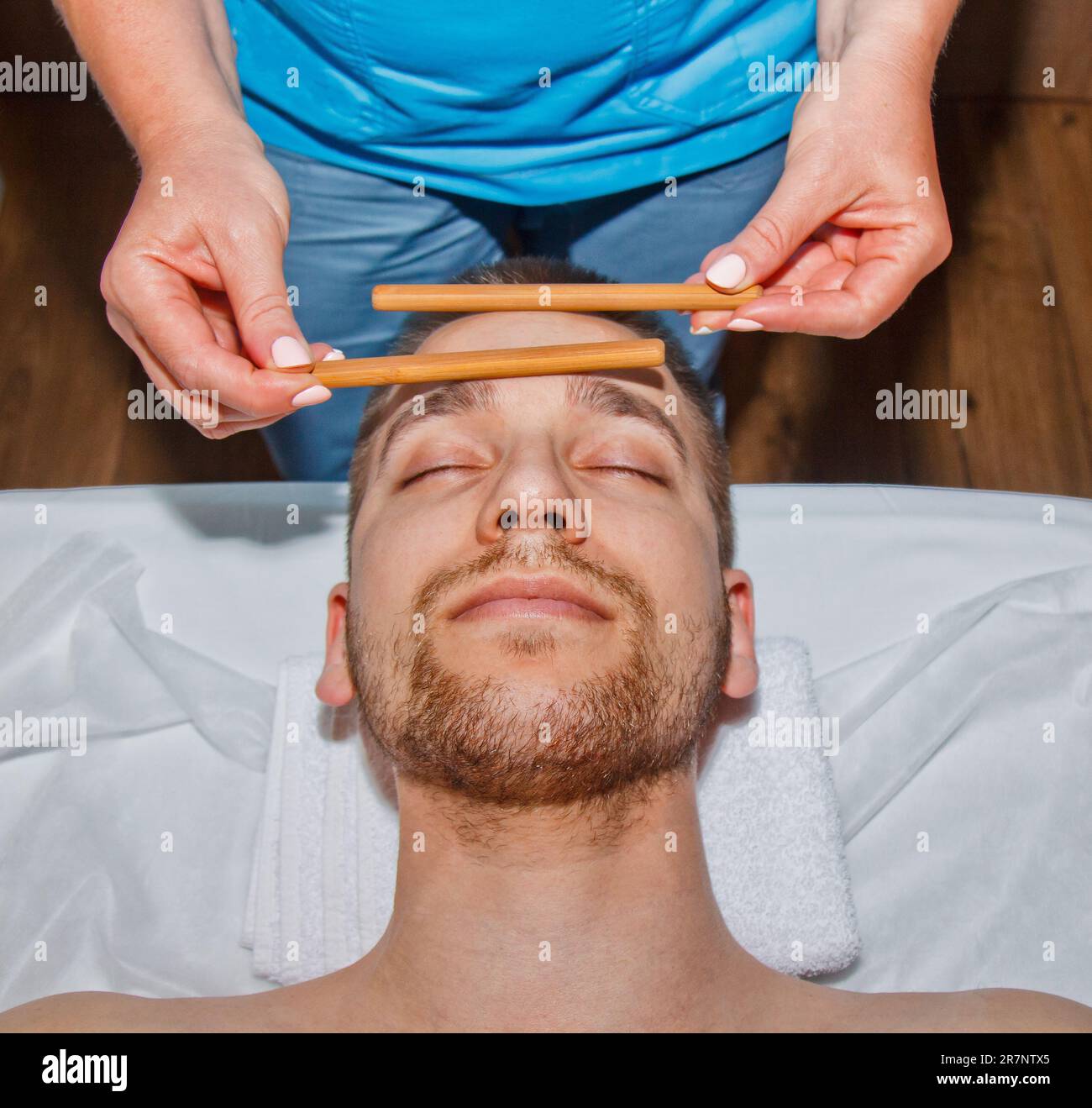 Wellness concept. Professional masseur gives a man a Thai facial ...