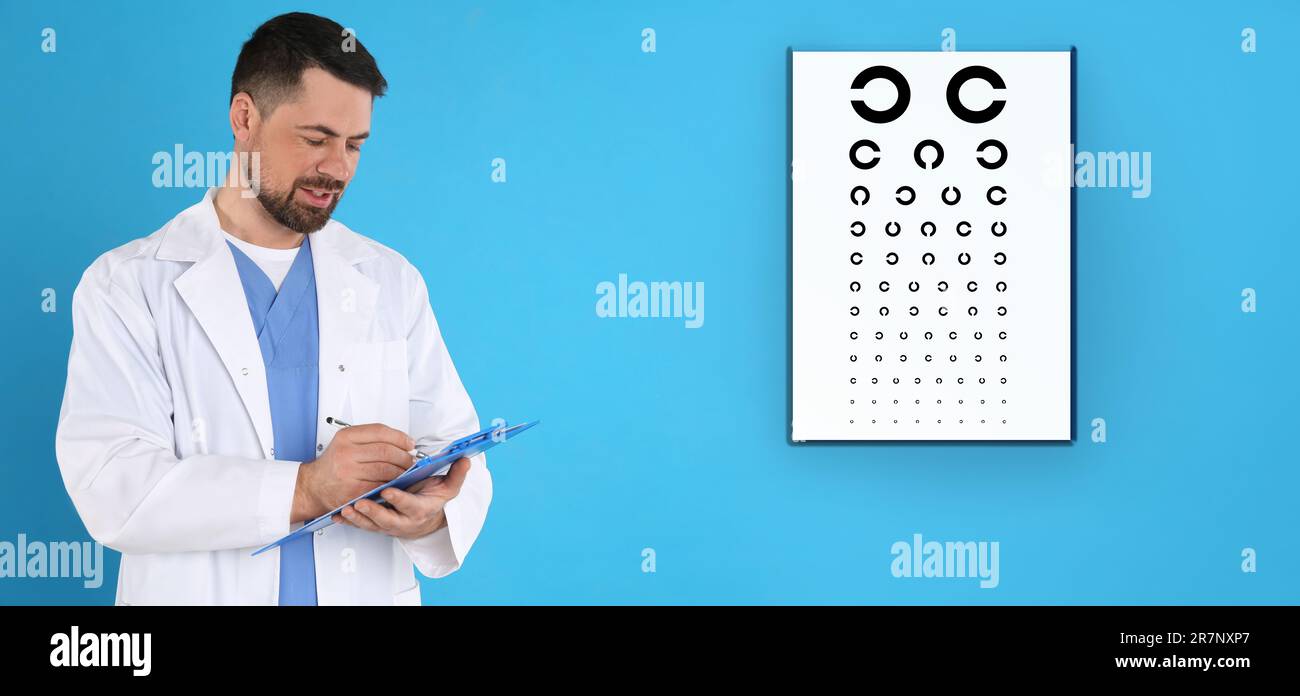 Vision test. Ophthalmologist or optometrist and eye chart on light blue ...