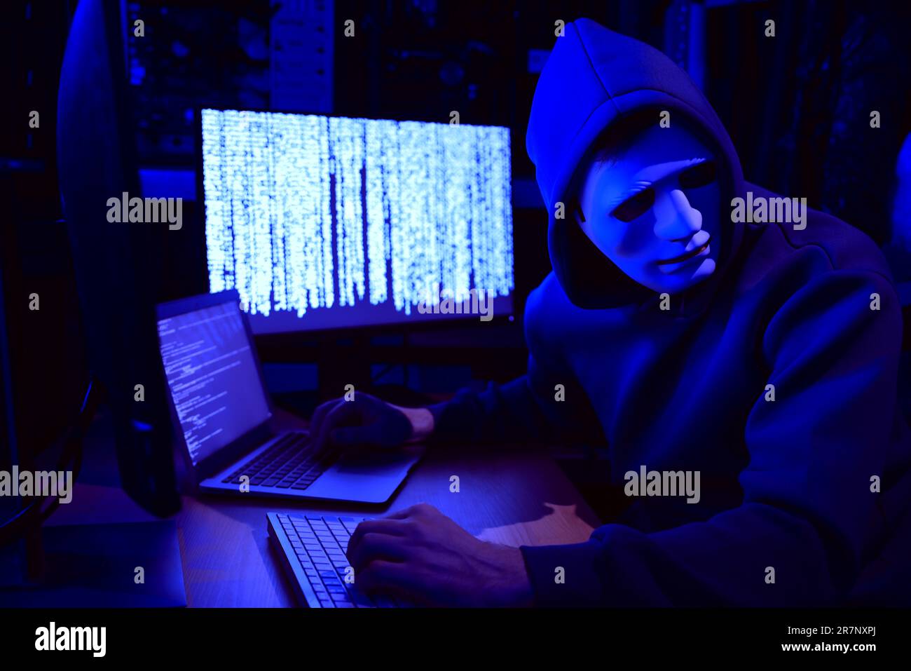 Hacker in mask working with computers in dark room. Cyber attack Stock ...