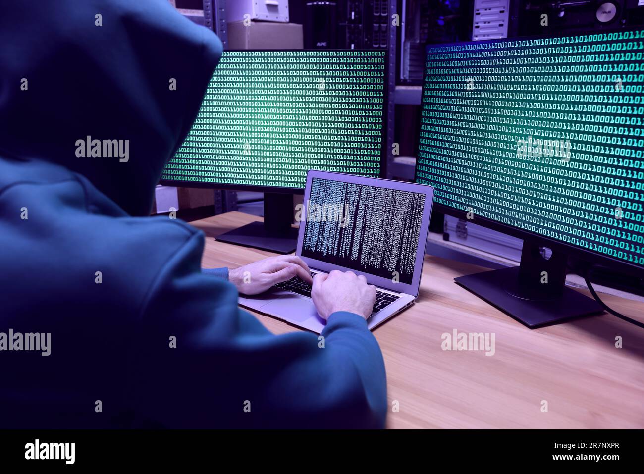 Hacker working with computers at wooden table indoors. Cyber attack ...
