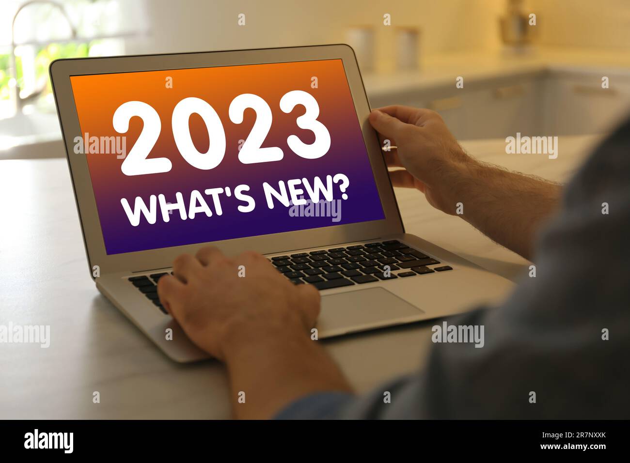 Future trends. 2023 What's New? text on laptop display. Man using ...