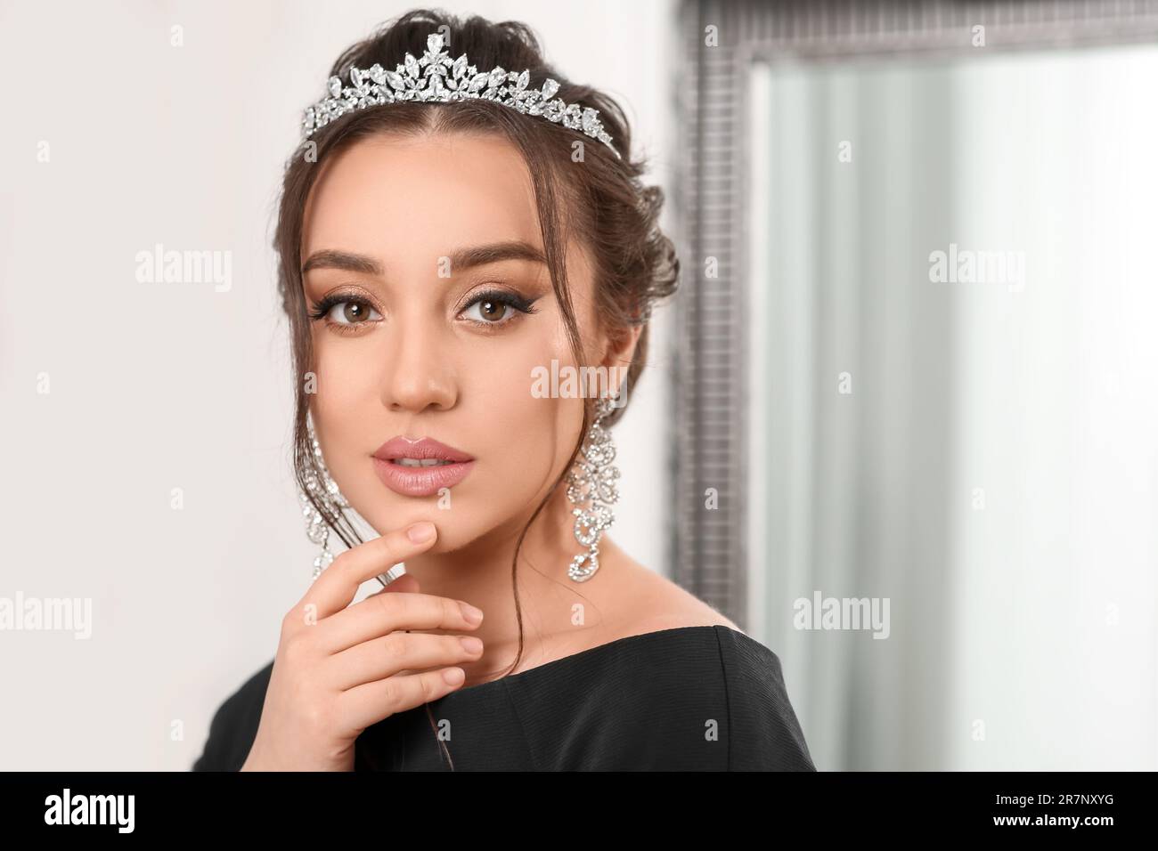 Beautiful young woman wearing luxurious tiara indoors, space for text Stock Photo - Alamy