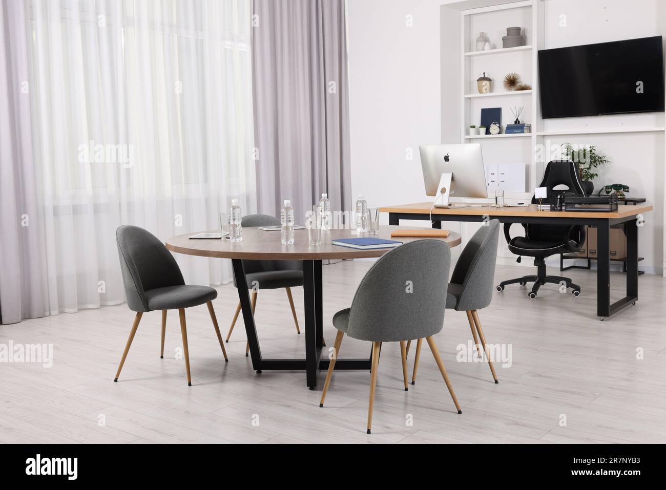 Stylish receptionist office with comfortable furniture, tv zone and ...