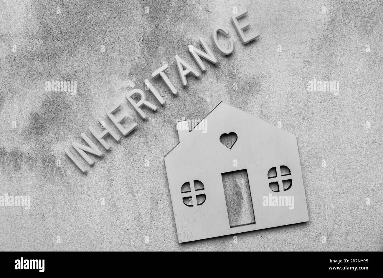 Word Inheritance made with white letters and model house on grey ...