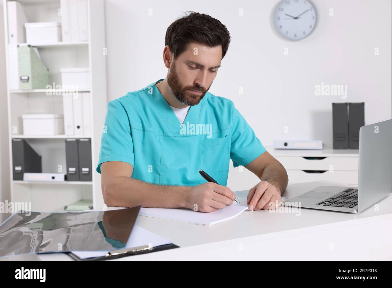 Doctor writing results from MRI scan in hospital Stock Photo - Alamy
