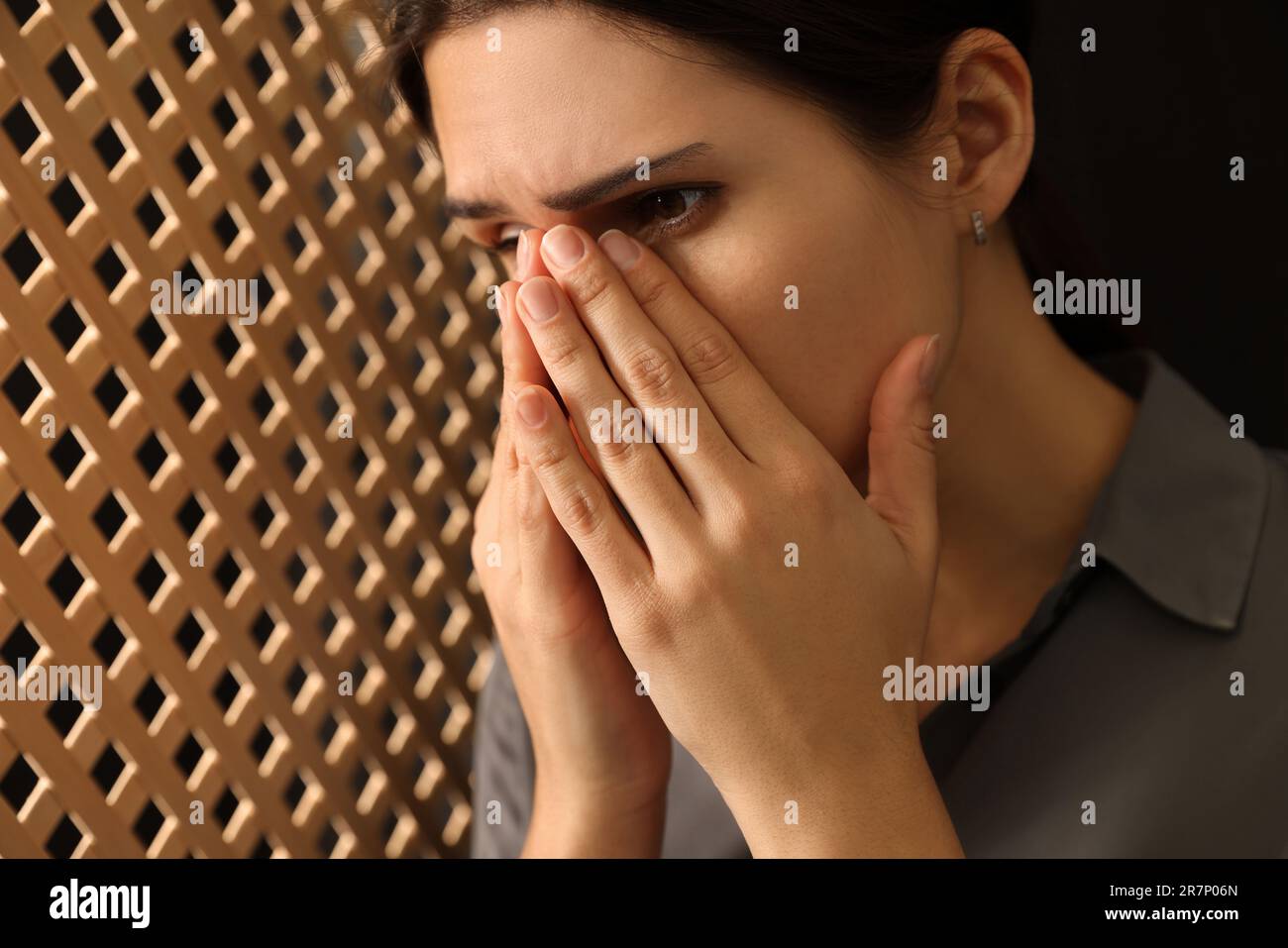 Young woman during confession in church hi-res stock photography and ...