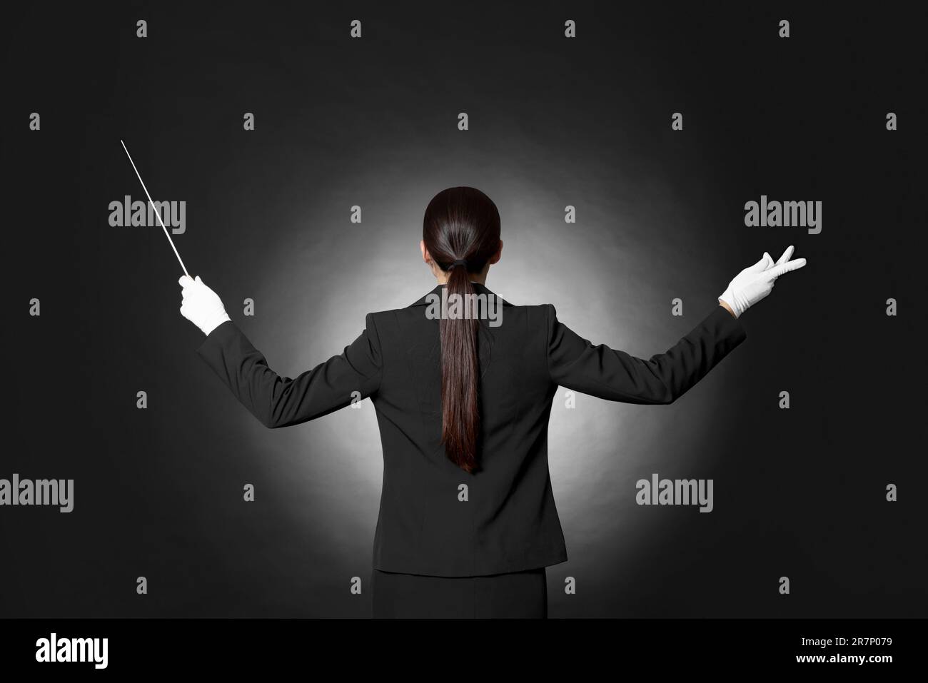 Professional conductor with baton on black background, back view Stock ...