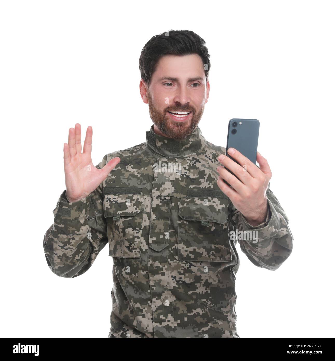 Happy soldier using video chat on smartphone against white background ...