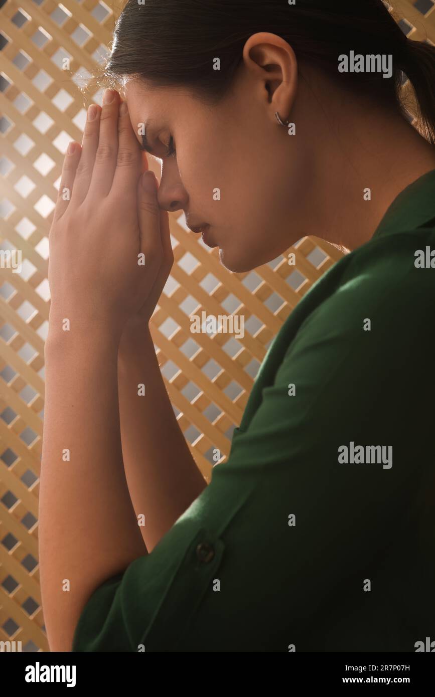 Young woman during confession in church hi-res stock photography and ...