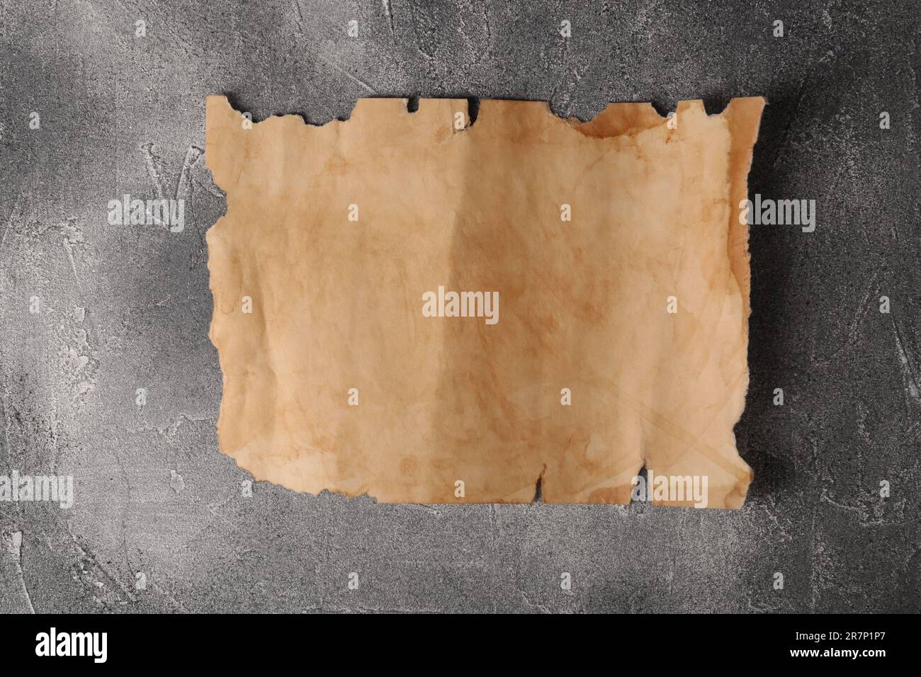 Sheet of old parchment paper on gray textured table, top view Stock ...