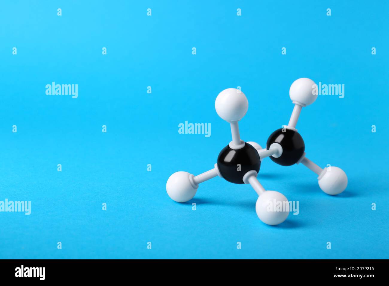 Molecule of alcohol on light blue background, space for text. Chemical ...