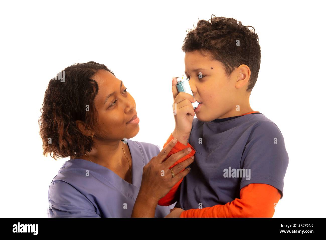 Healthcare professional assisting 7 year old boy using inhaler Stock ...