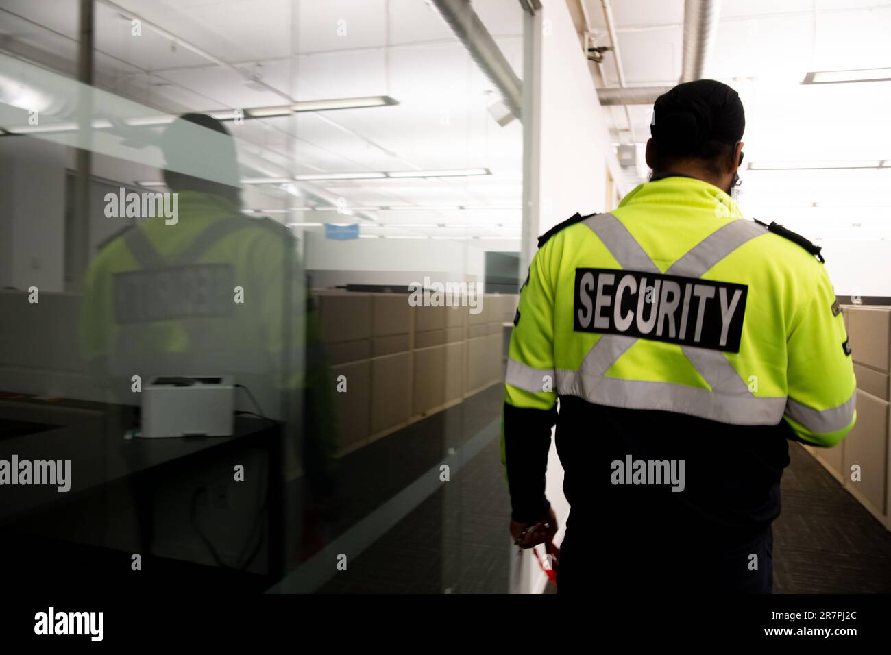 Security guard patrolling at night office Stock Photo - Alamy