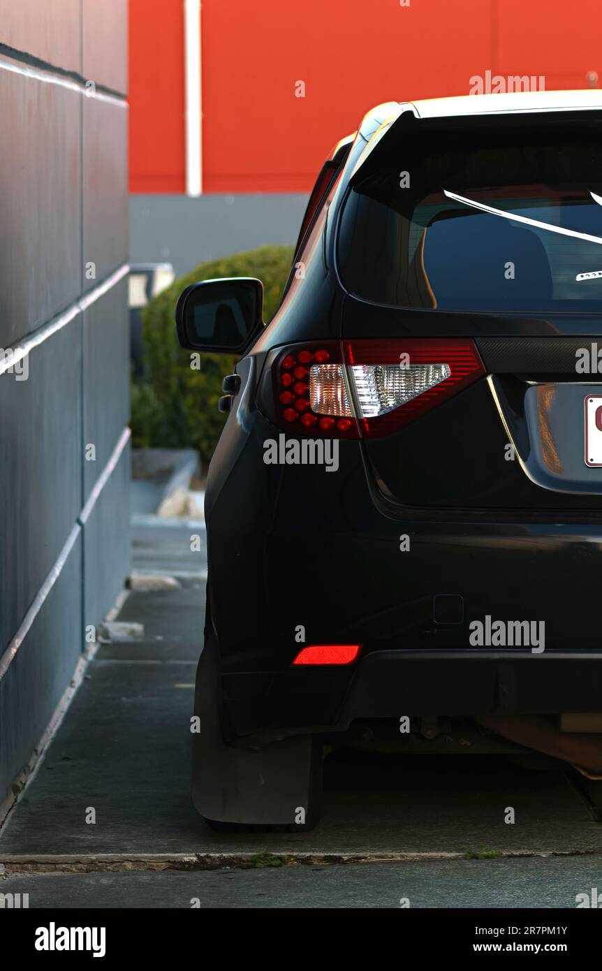 Random street photography of a black small car rear end, cropped to ...