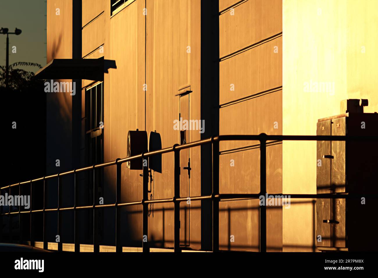 Random street photography of a side of a building with a railing at ...