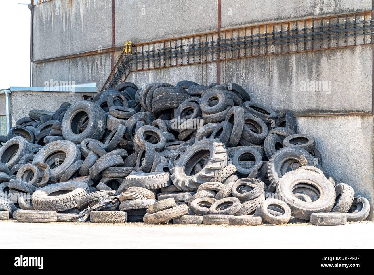 warehouse of used tires, recycling and processing Stock Photo - Alamy