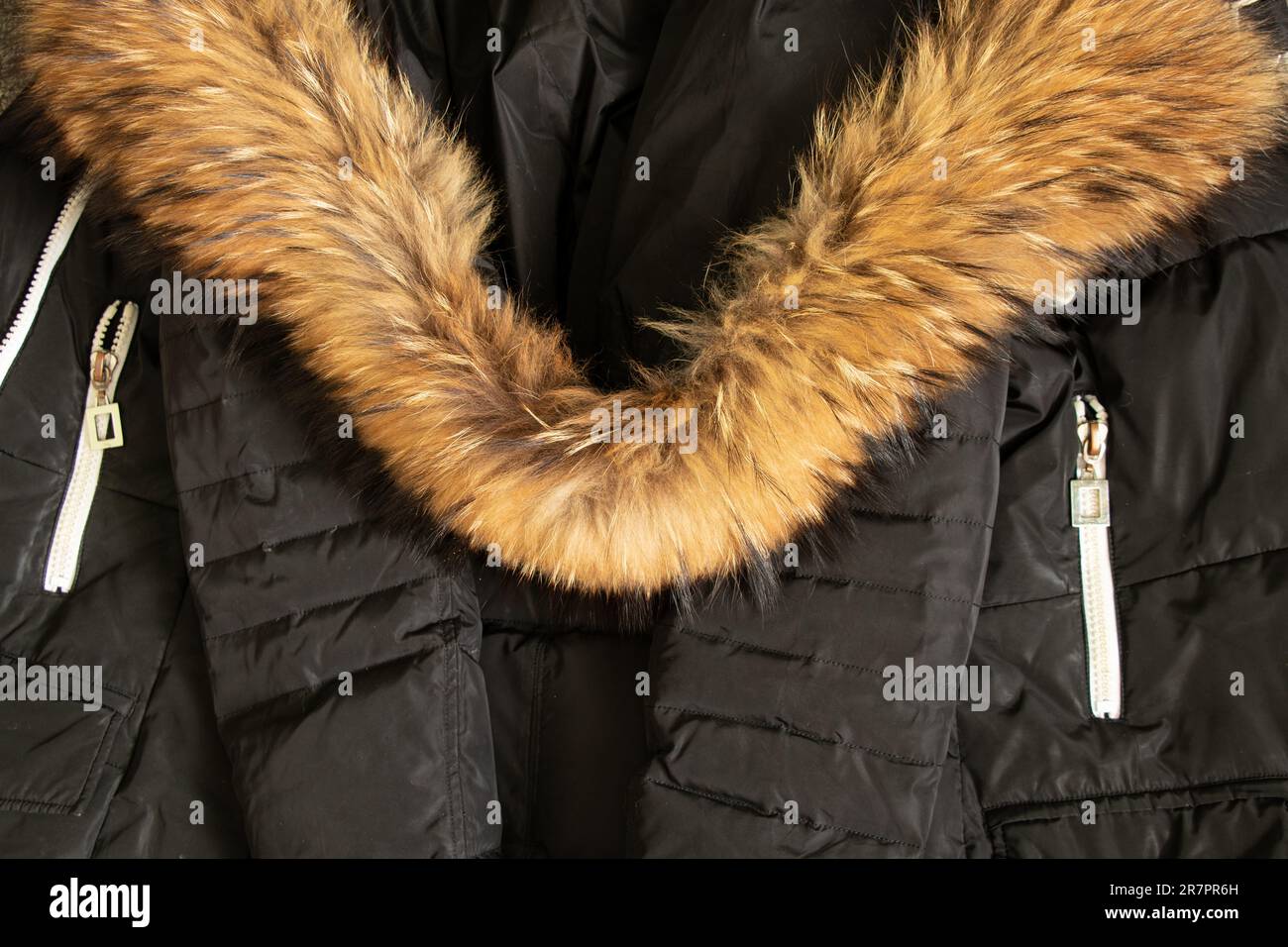 black women's down jacket with a fur collar on the hood as a background ...