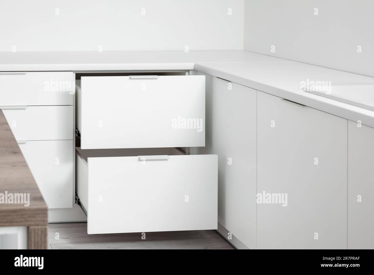 Open white drawers in light kitchen Stock Photo - Alamy