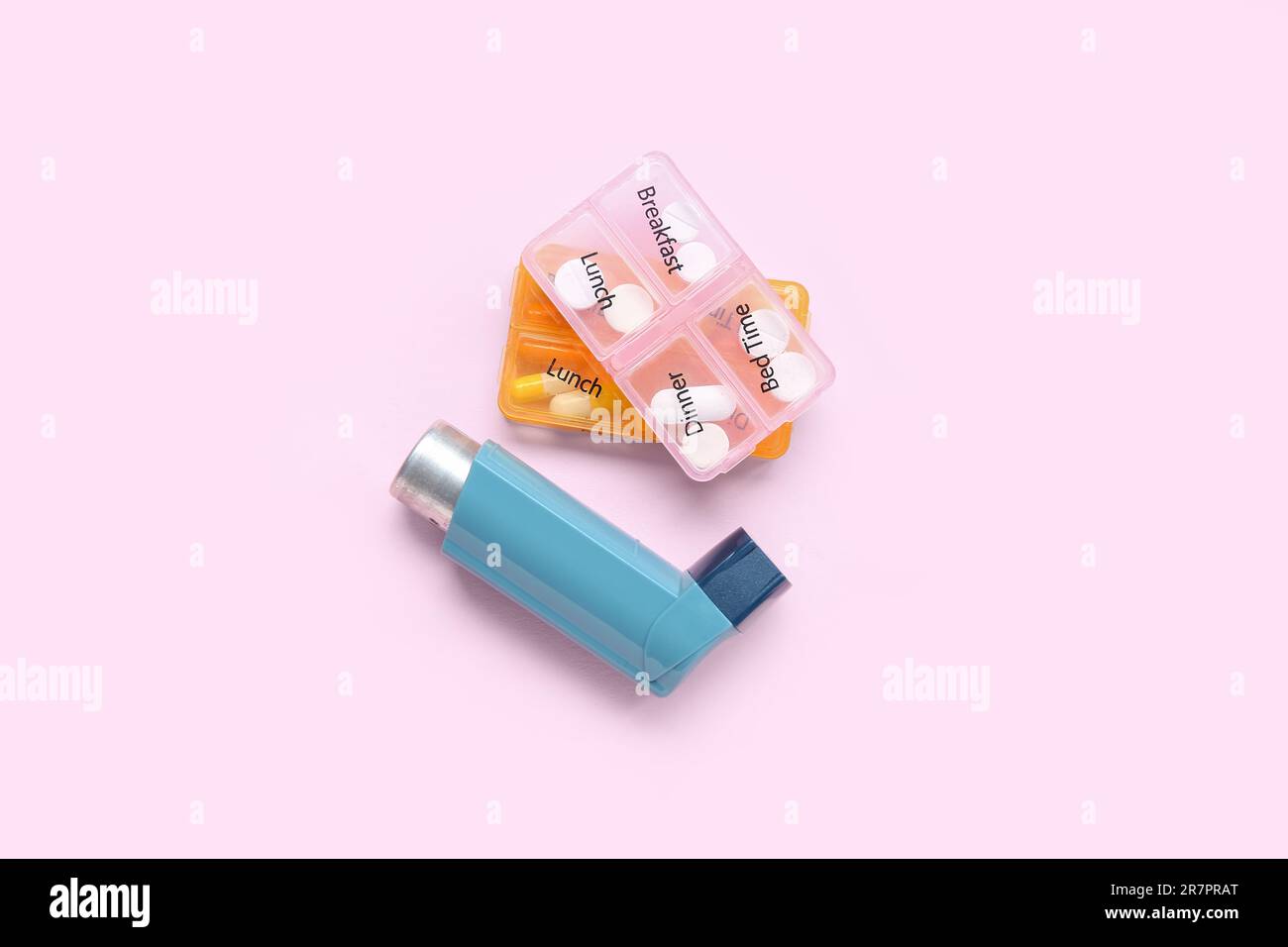Asthma inhaler and boxes with pills on pink background Stock Photo - Alamy