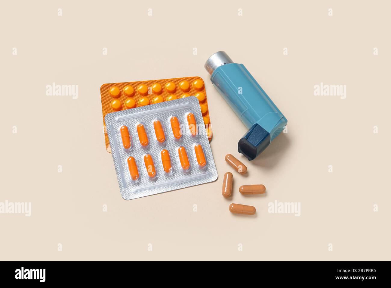 Asthma inhaler and pills on beige background Stock Photo - Alamy