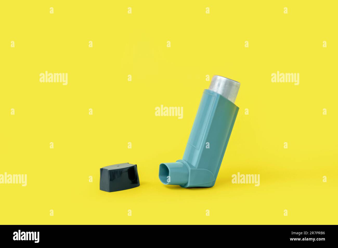 Asthma inhaler on yellow background Stock Photo - Alamy