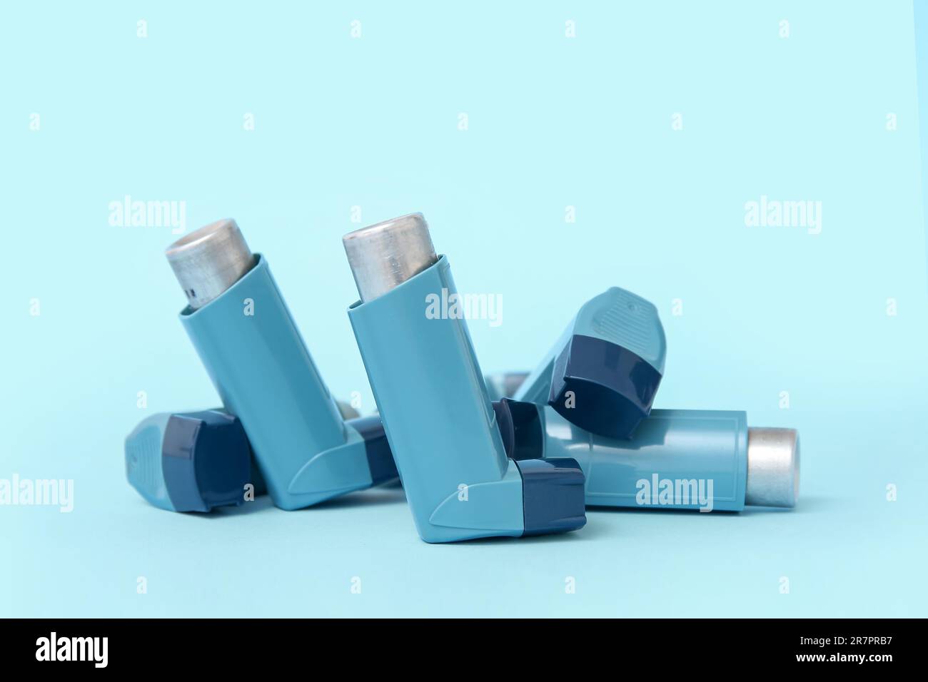 Asthma inhalers on blue background Stock Photo - Alamy