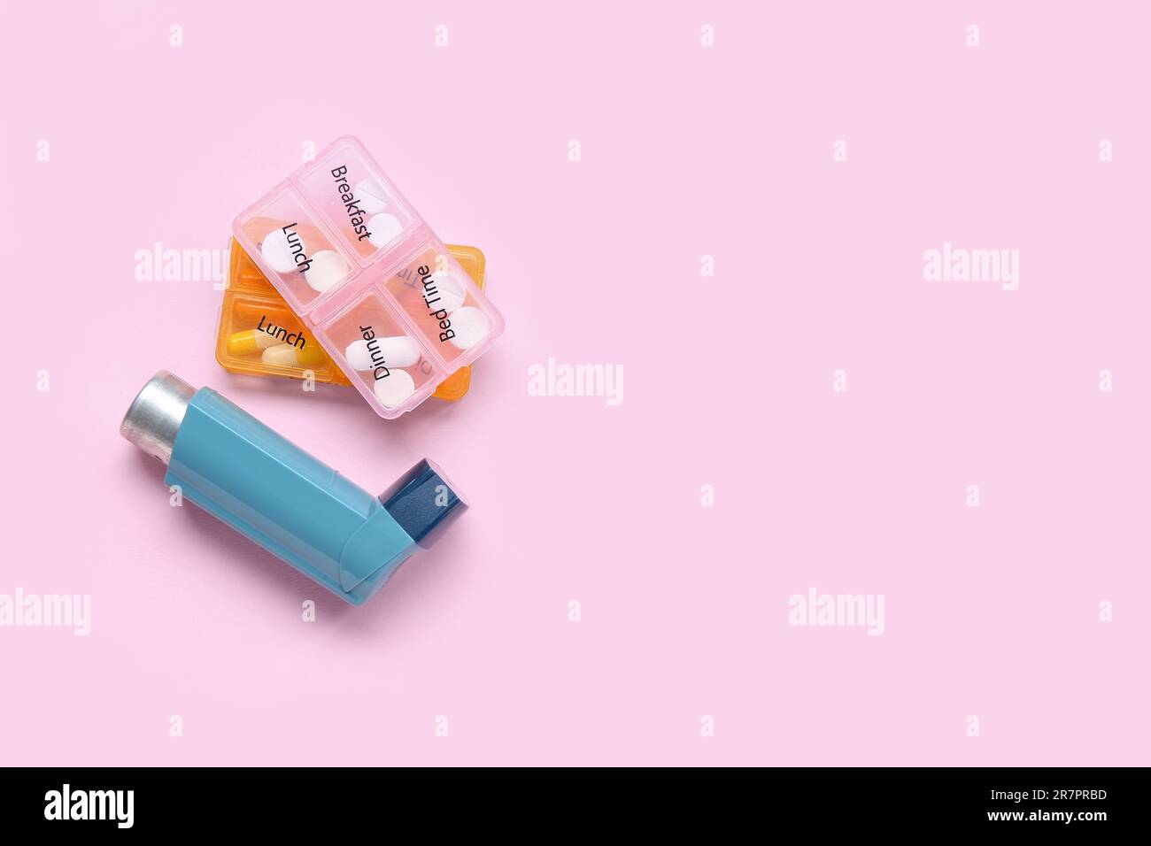 Asthma inhaler and boxes with pills on pink background Stock Photo - Alamy