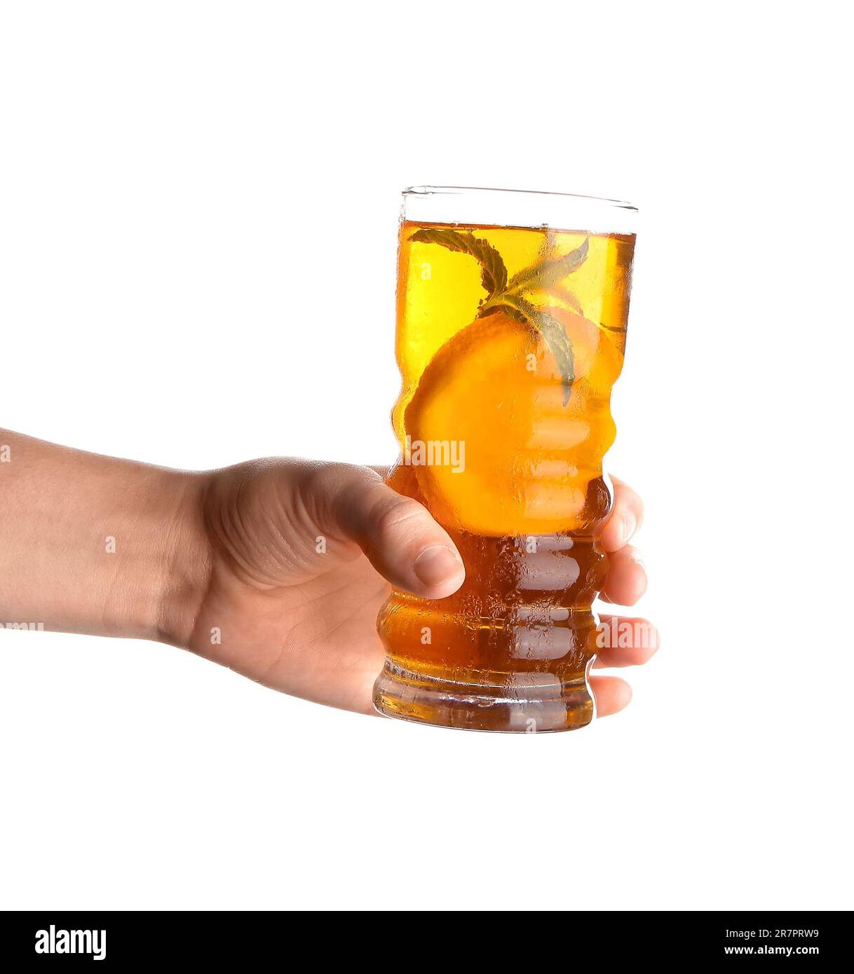 Female hand holding glass of ice tea with orange on white background ...