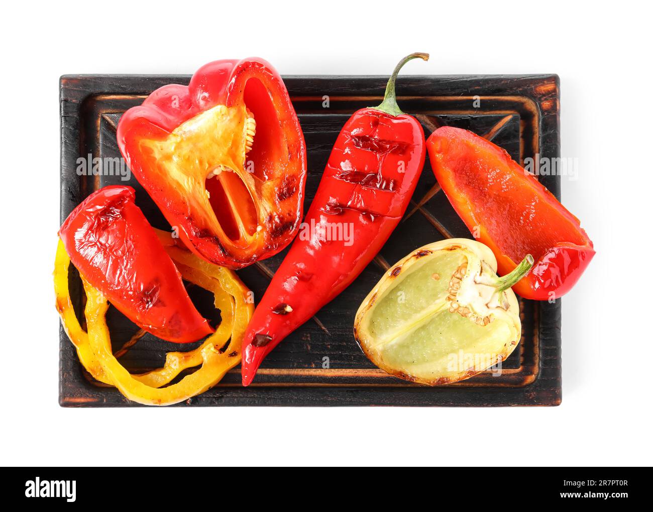 Wooden board with tasty grilled peppers isolated on white background ...