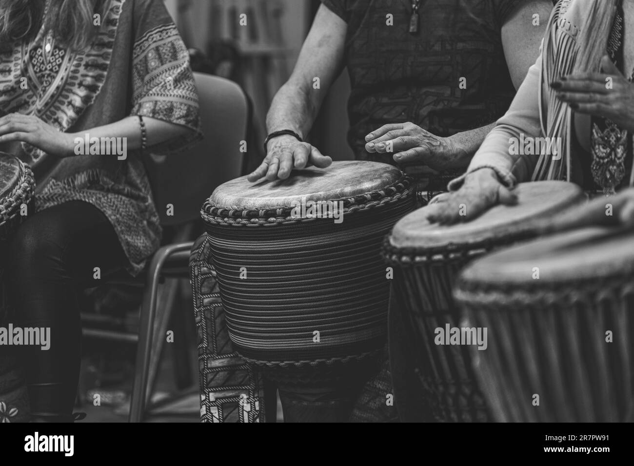 A diverse group of people enjoying a fun and lively drumming session ...